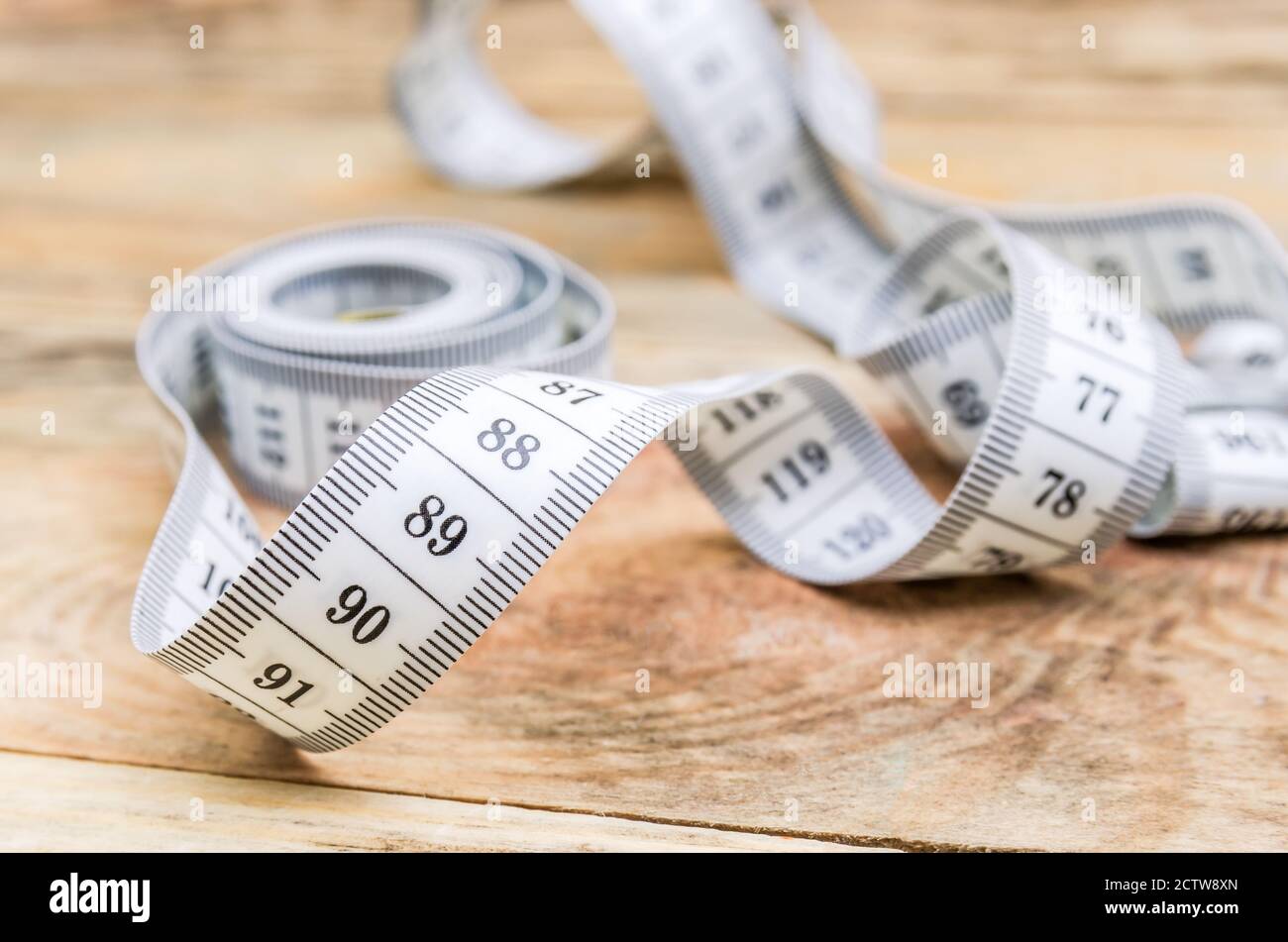 White measuring tape, centimeter on a blue background close-up Stock ...