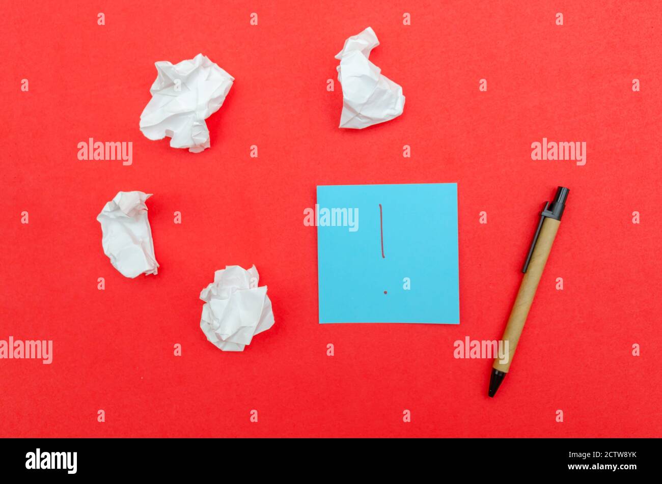 Blue sheet of paper with an exclamation mark, crumpled paper and pen on ...