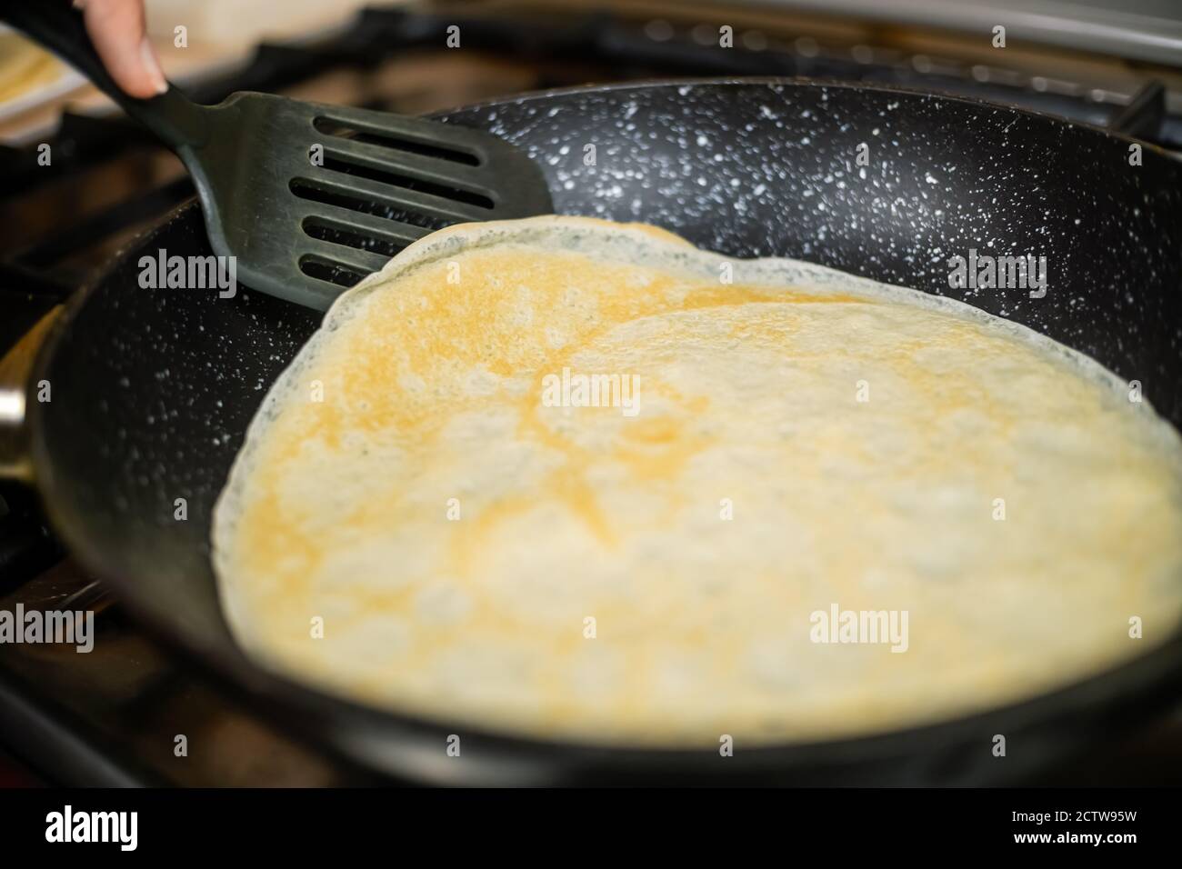 Cook kitchen spatula turns pancake hi-res stock photography and images ...