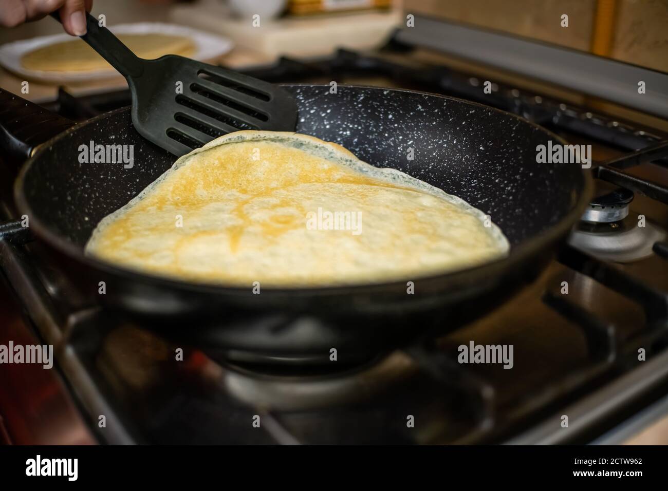 Cook kitchen spatula turns pancake hi-res stock photography and images ...