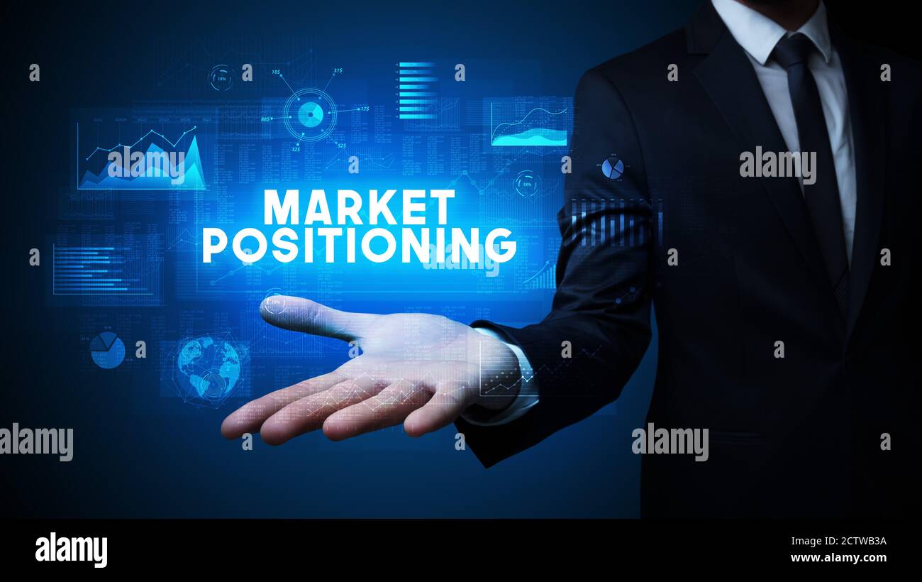 Hand of Businessman holding MARKET POSITIONING inscription, business ...