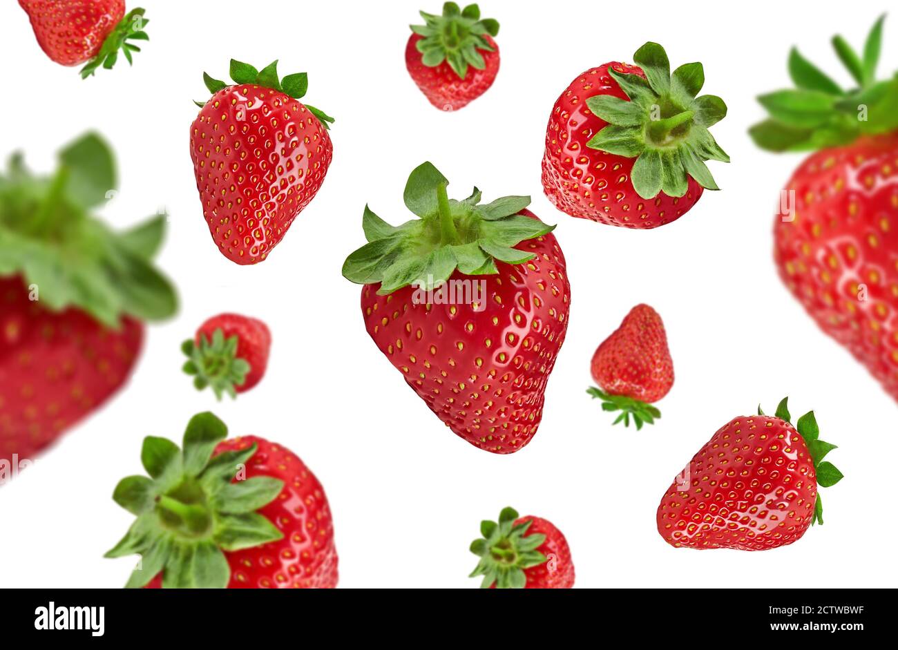 Falling juicy strawberries isolated on white background. Summer harvest ...