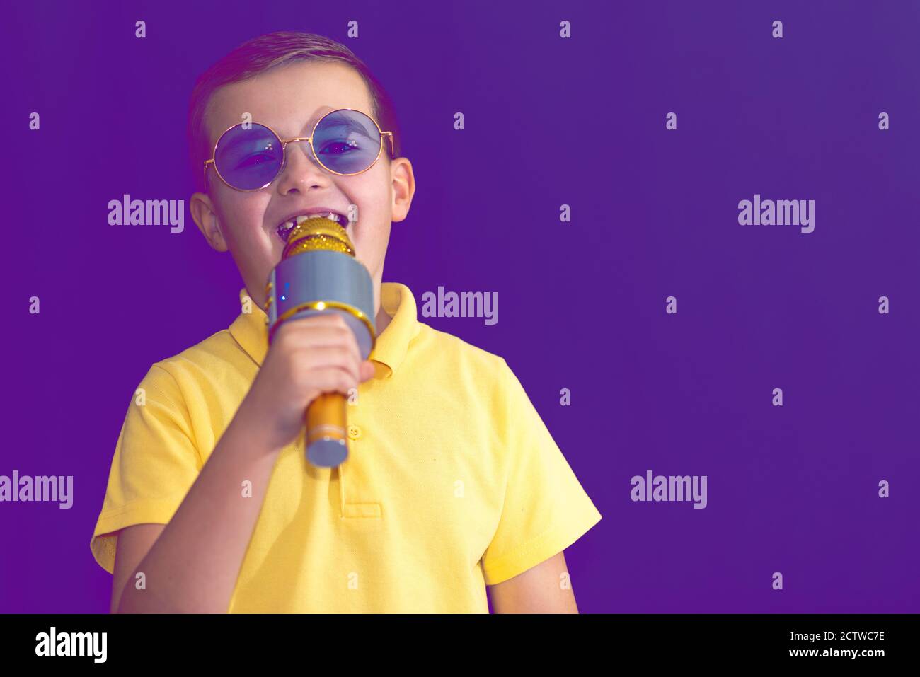 Close up image.The young boy kid child 9s old in yellow t shirt and ...