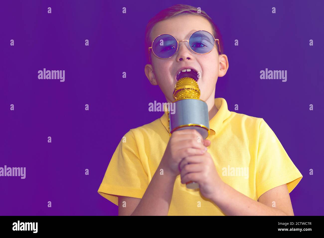 Close up image.The young boy kid child 9s old in yellow t shirt and ...