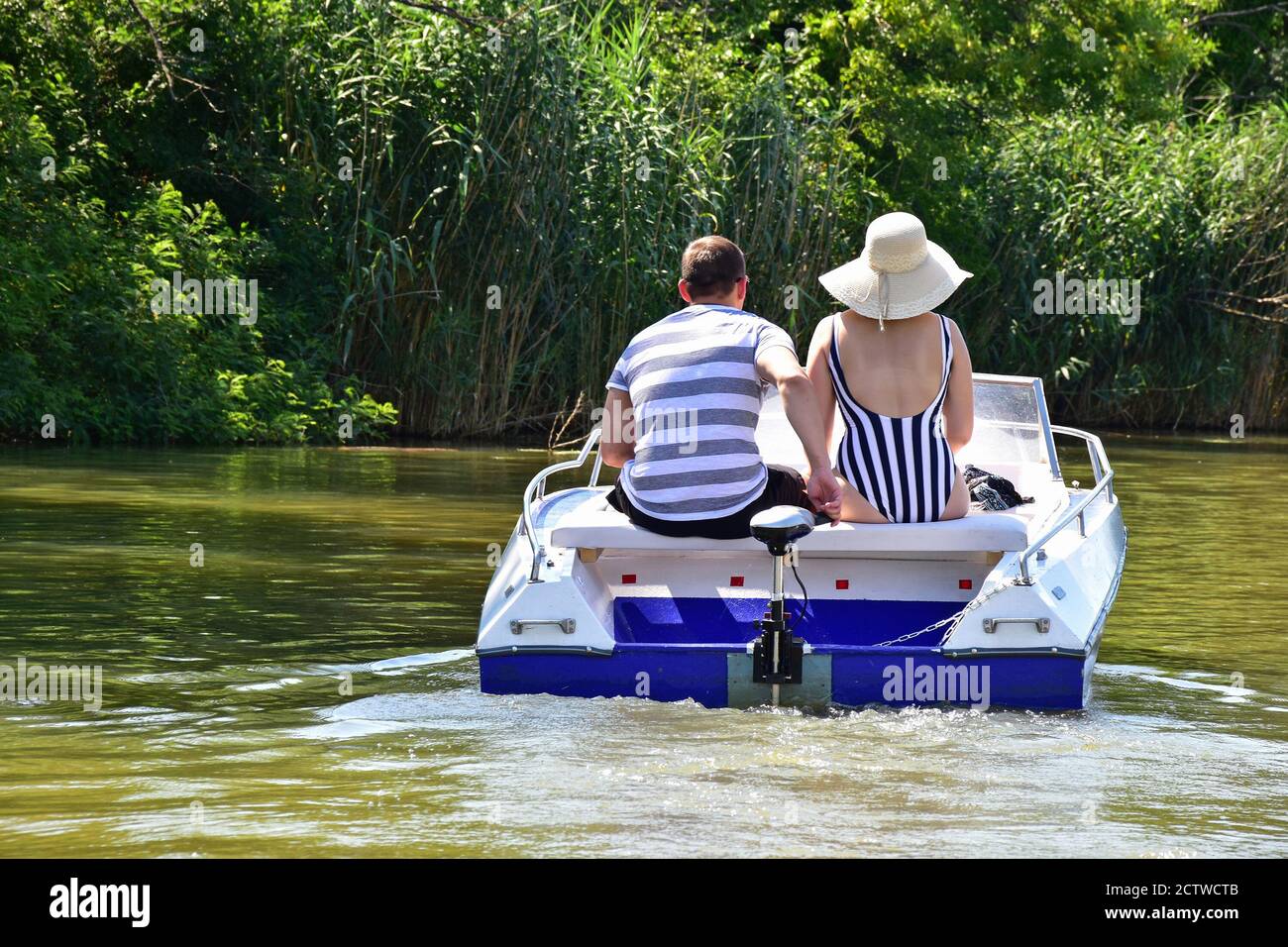 Rear view of a man sitting on a boat hi-res stock photography and ...
