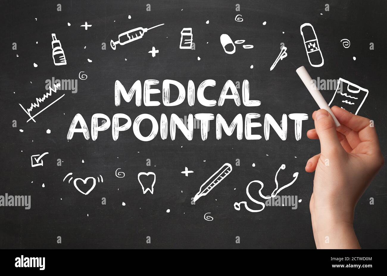 Hand drawing MEDICAL APPOINTMENT inscription with white chalk on ...