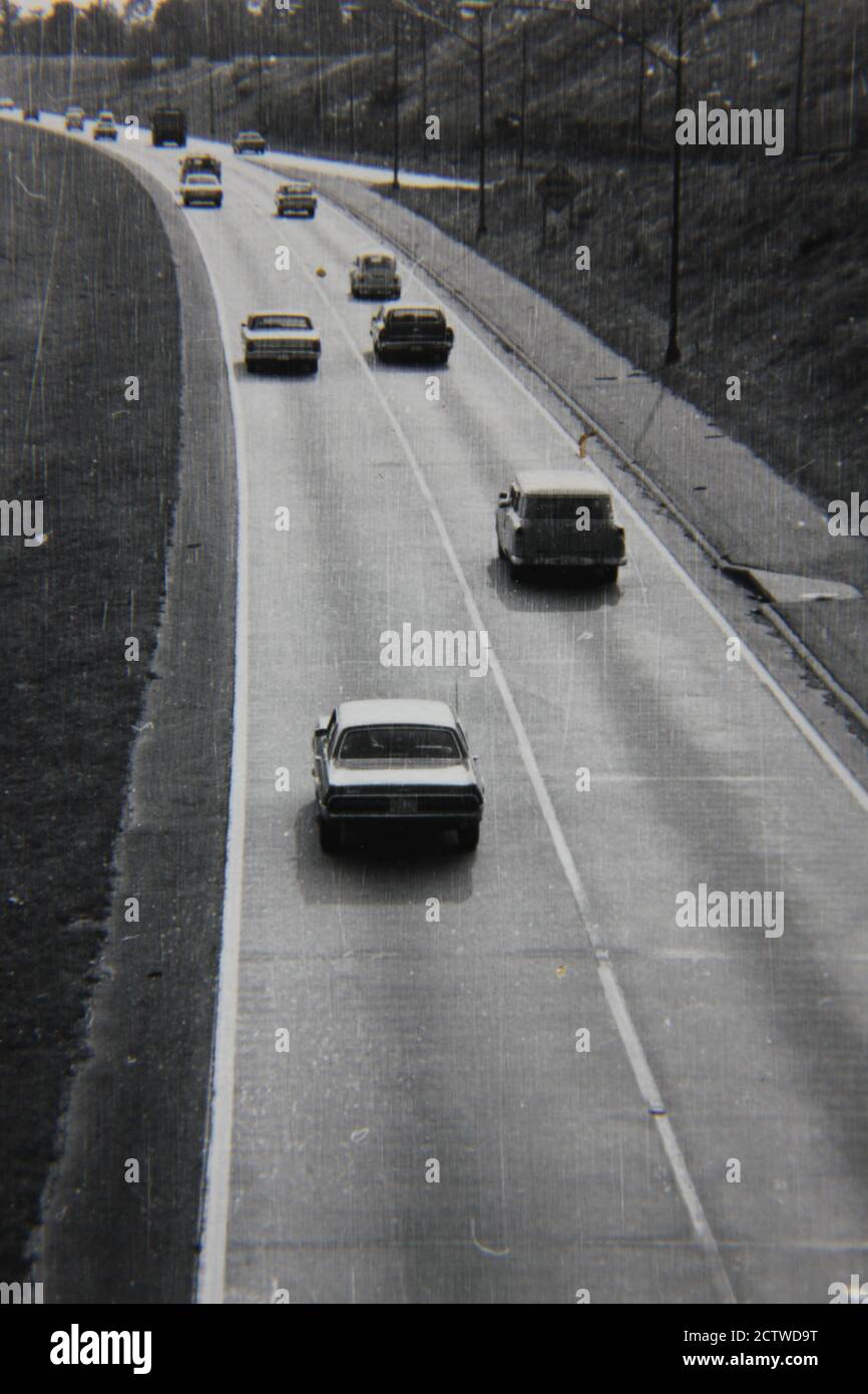 Fine 1970s vintage black and white photography of cars driving down the ...