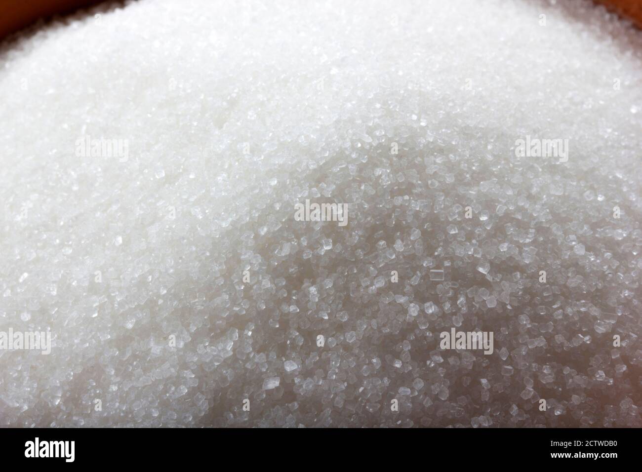 Granulated sugar in bowl. Crystals of refined table sugar. Sweet ...
