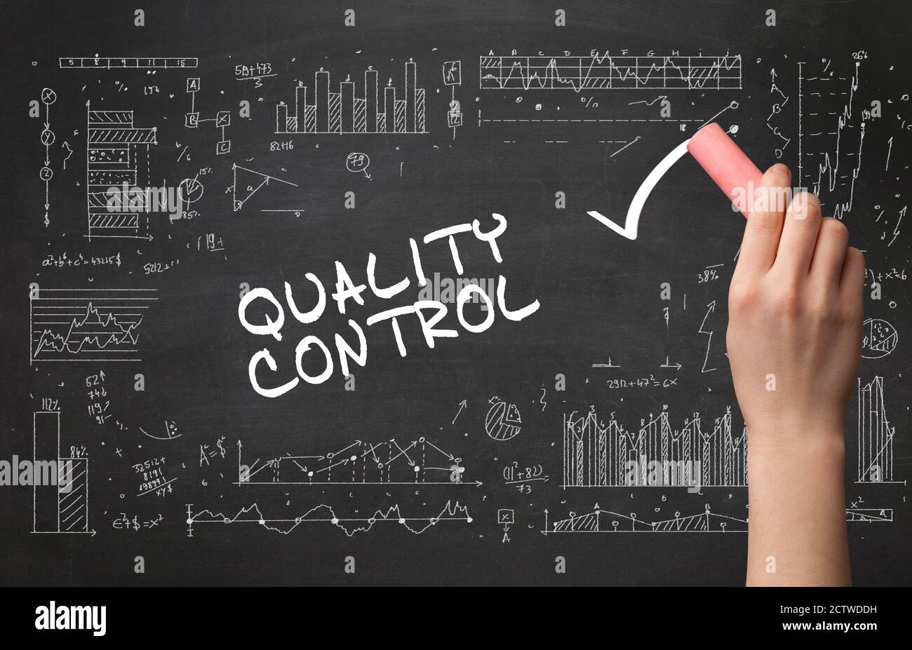 Hand drawing QUALITY CONTROL inscription with white chalk on blackboard ...