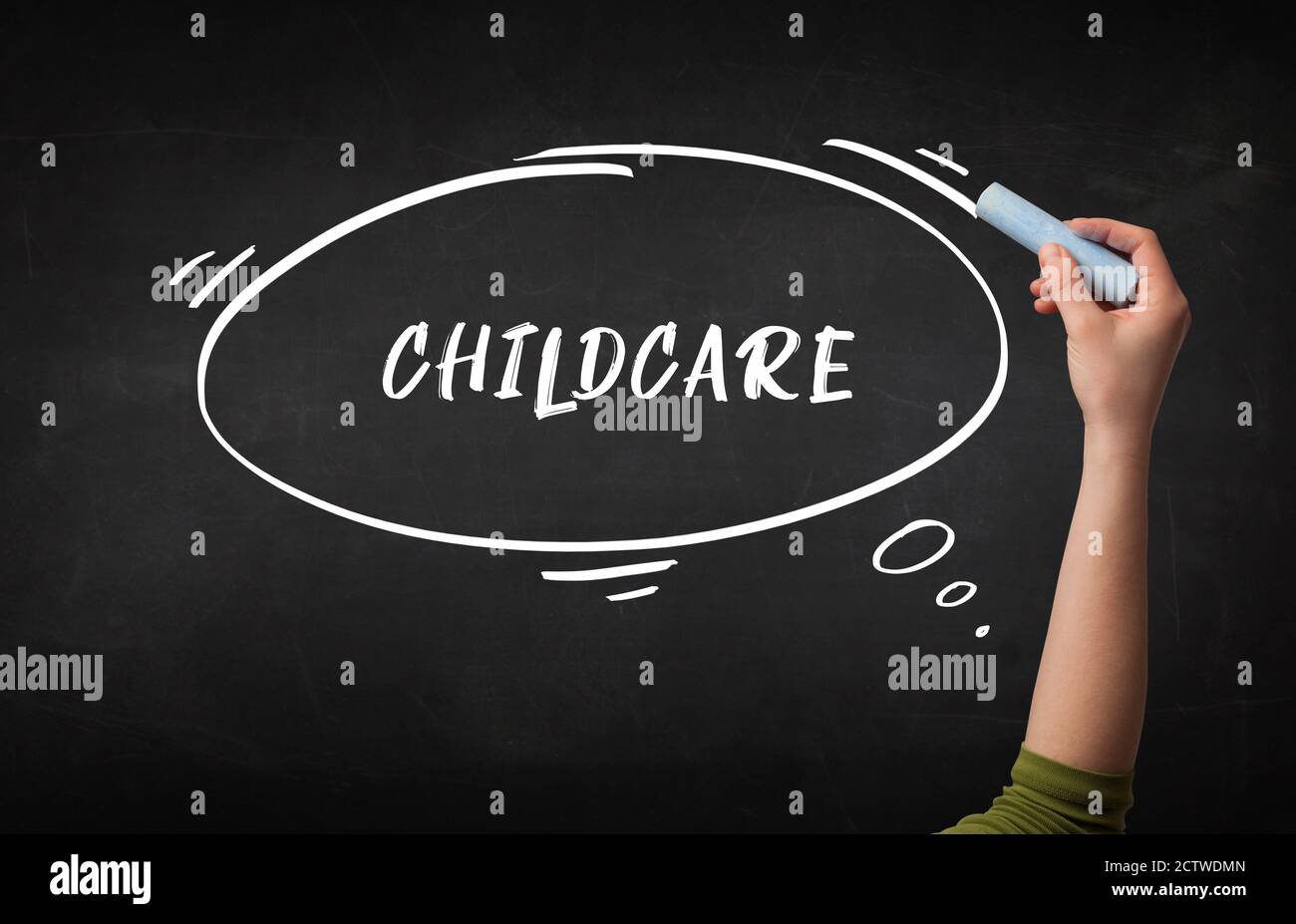 Hand drawing CHILDCARE inscription with white chalk on blackboard ...