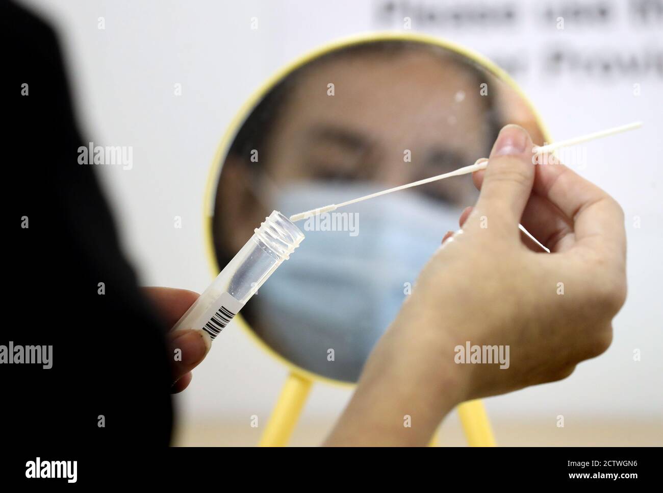 Esther Lynn demonstrates how to take a coronavirus test at a new walk ...