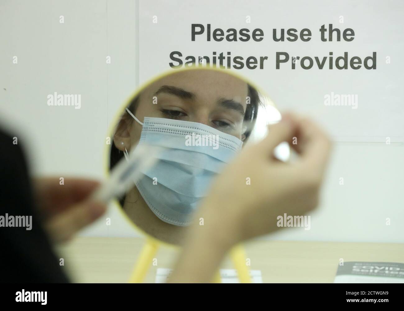 Esther Lynn demonstrates how to take a coronavirus test at a new walk ...