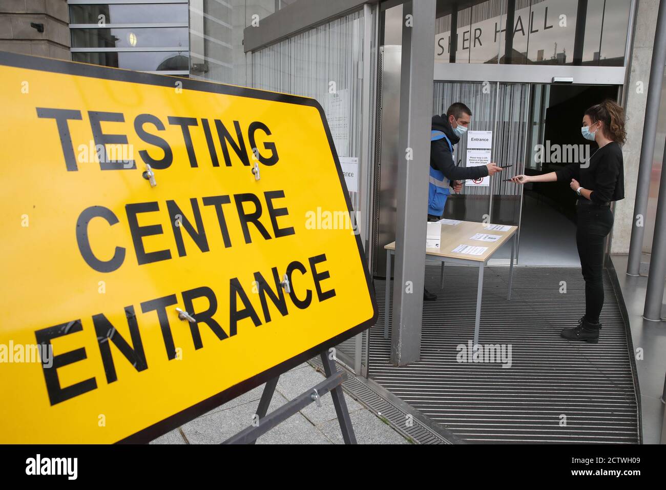 Esther Lynn demonstrates how her QR code is read at the entrance to a ...