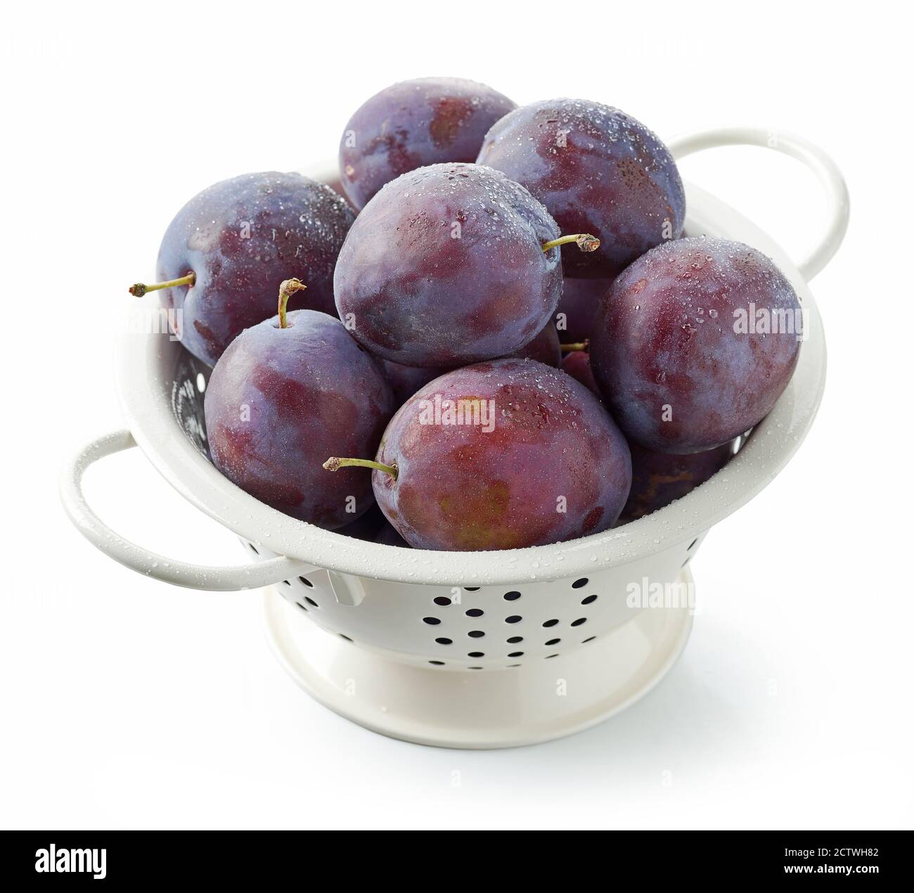 fresh wet ripe plums in colander isolated on white background Stock ...