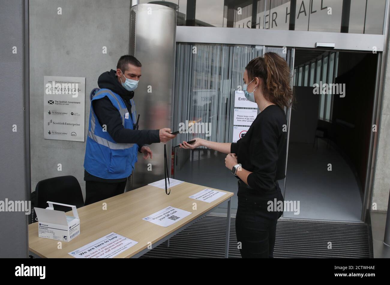 Esther Lynn demonstrates how her QR code is read at the entrance to a ...