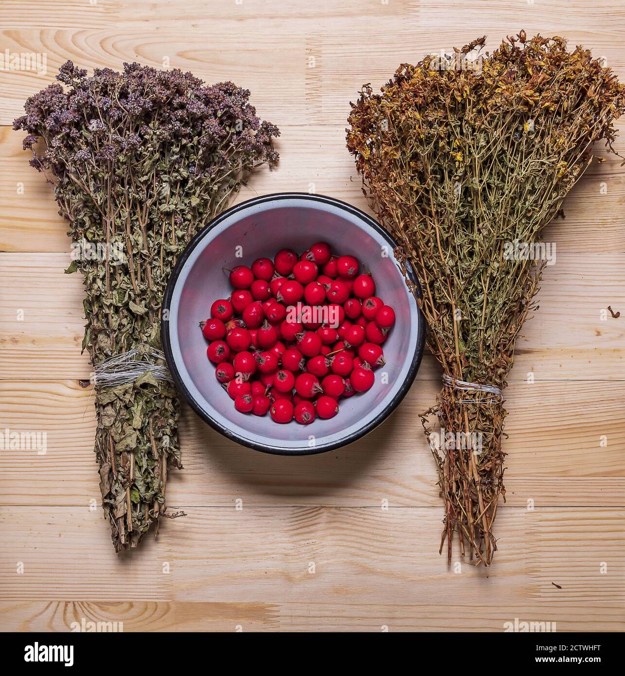 Medicinal and medicinal berries and herbs lie on a wooden table Stock ...