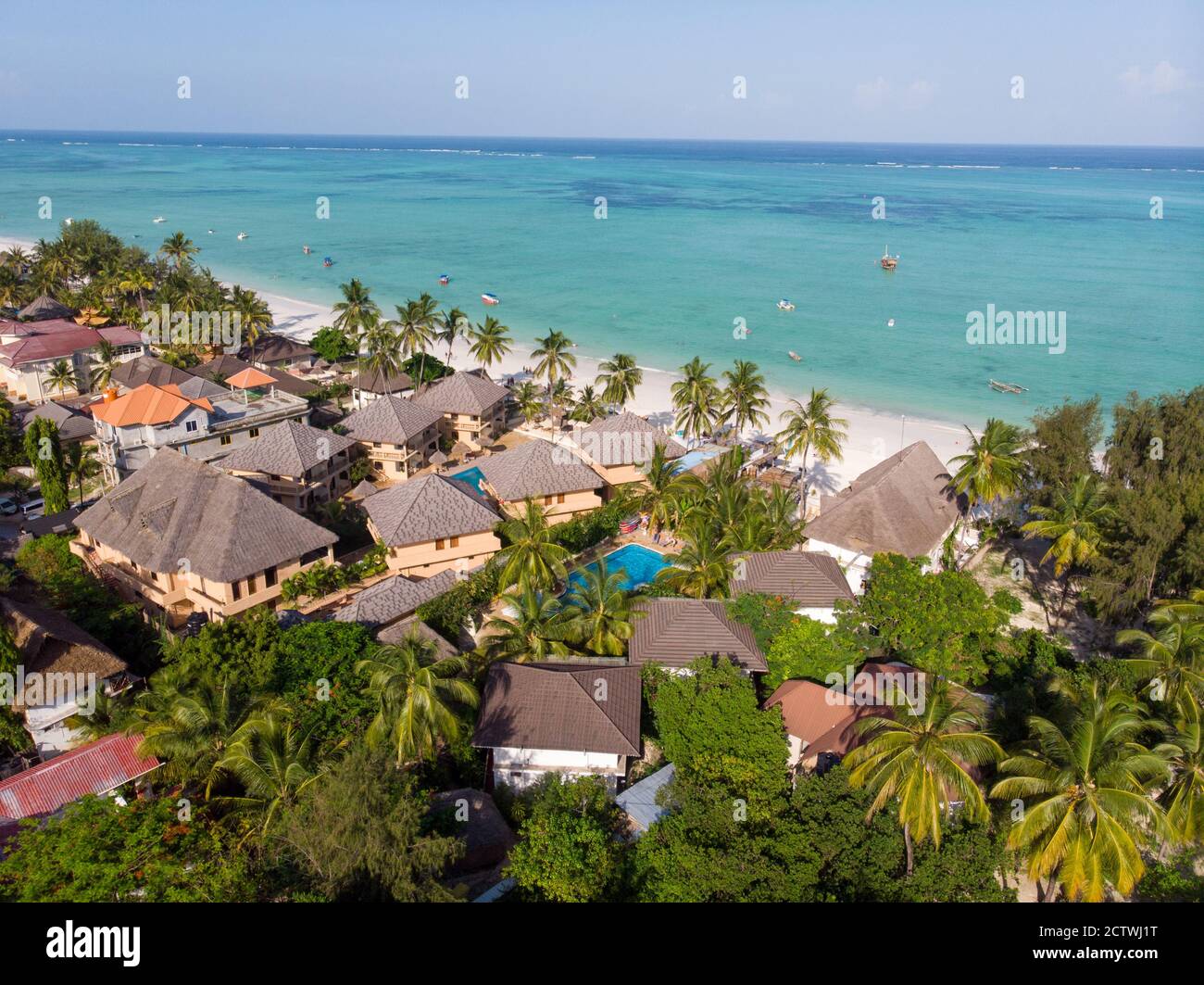Aerial shot of a luxury hotel on a Beach first line with Palm Trees ...