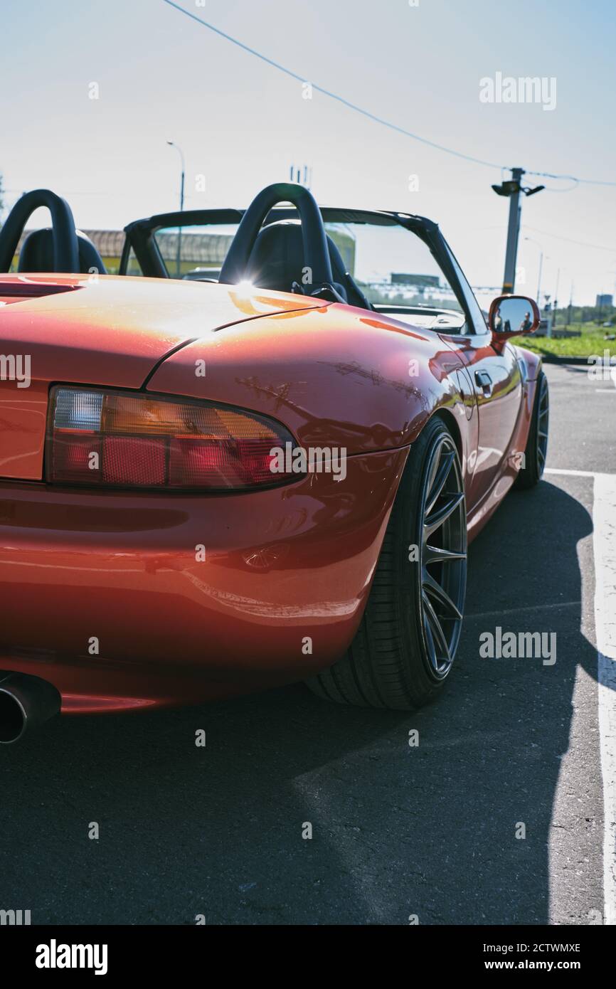 Vertical shot of a parked new stylish red convertible sports car ...