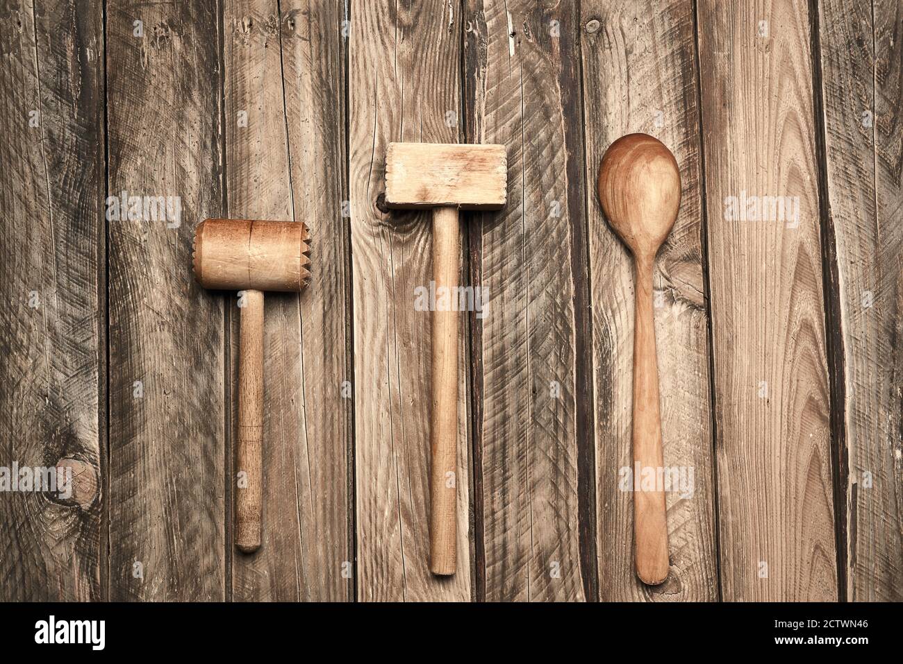 wooden kitchen hammer and spoon on a background of gray boards, top ...