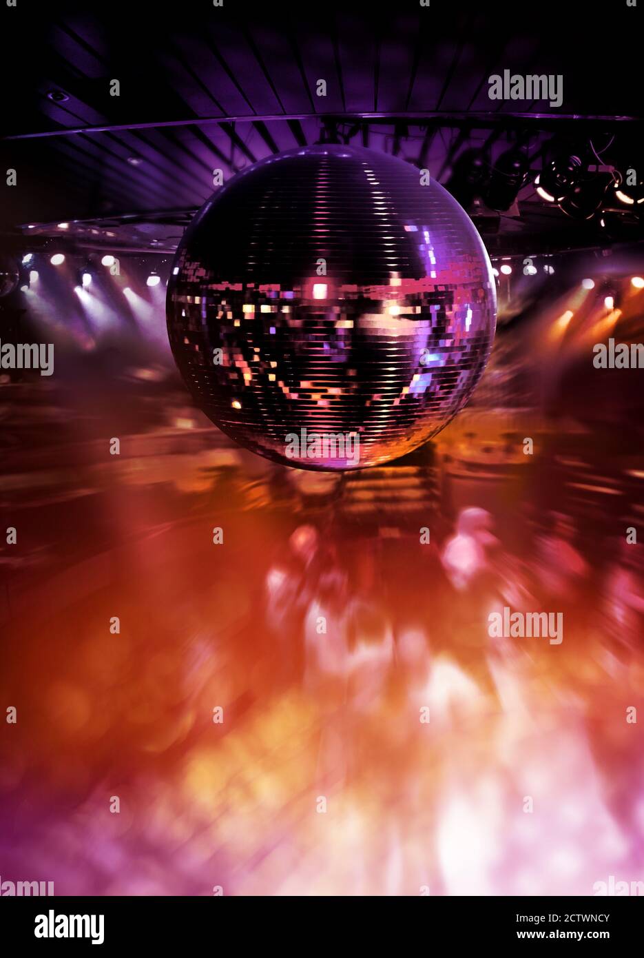 People dancing in hot disco under colorful lights of mirror ball Stock ...
