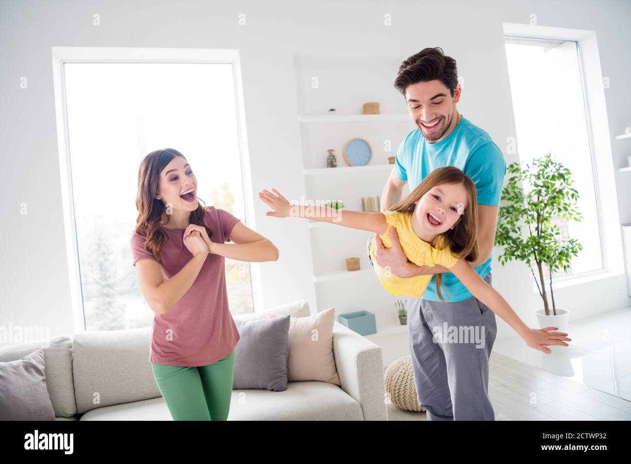 Photo of positive cheerful three people play game dad carry little kid ...