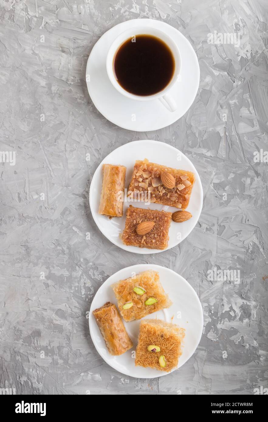 traditional arabic sweets (basbus, kunafa, baklava) on white plate and ...