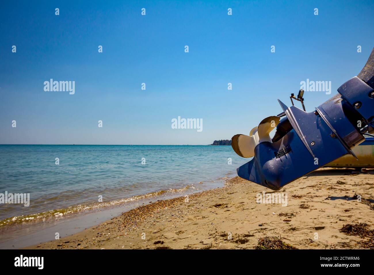View on propeller of motorboat on the sandy beach, foamy waves are ...