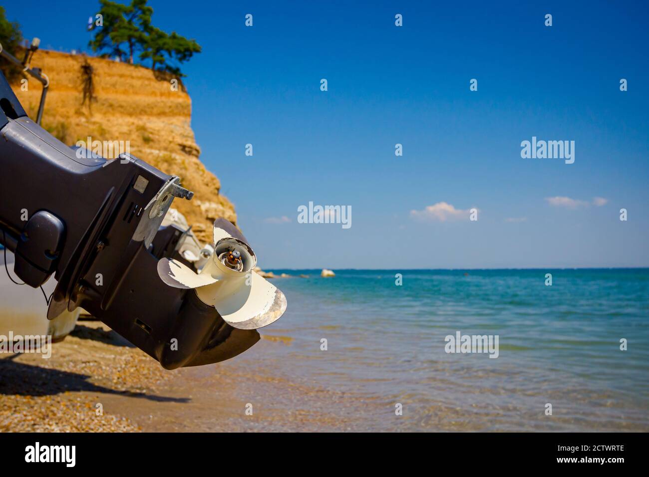 View on propeller of motorboat on the sandy beach, foamy waves are ...