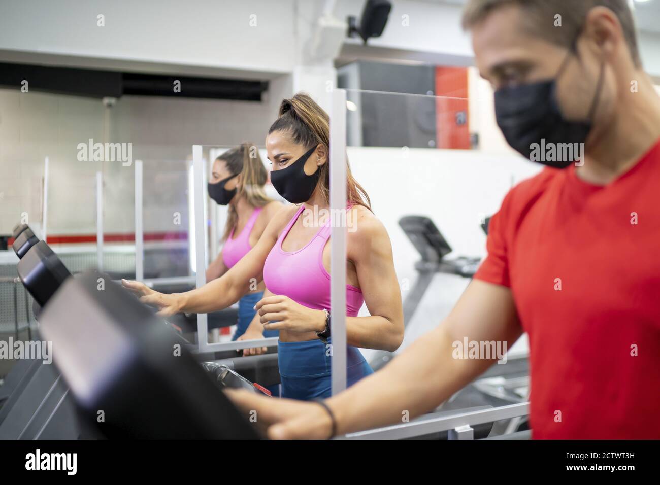 Closeup of people exercising in the gym in facial masks - concept of ...