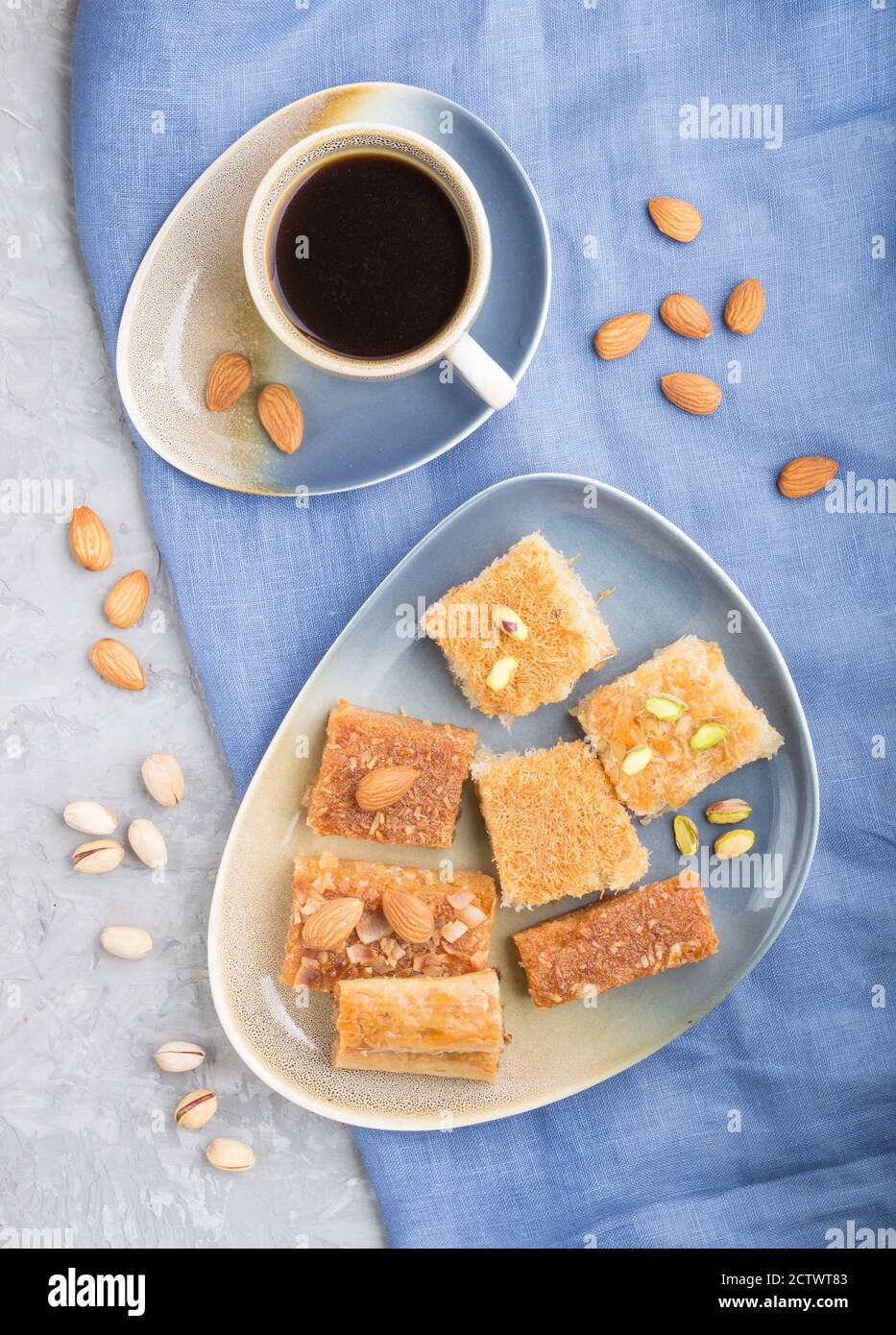 traditional arabic sweets (basbus, kunafa, baklava) and a cup of coffee ...