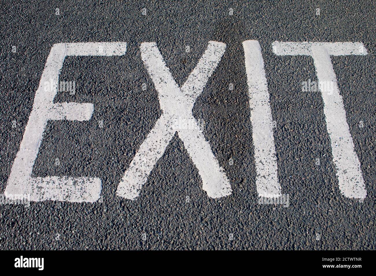 The word EXIT apinted on the pavement of a car park Stock Photo - Alamy