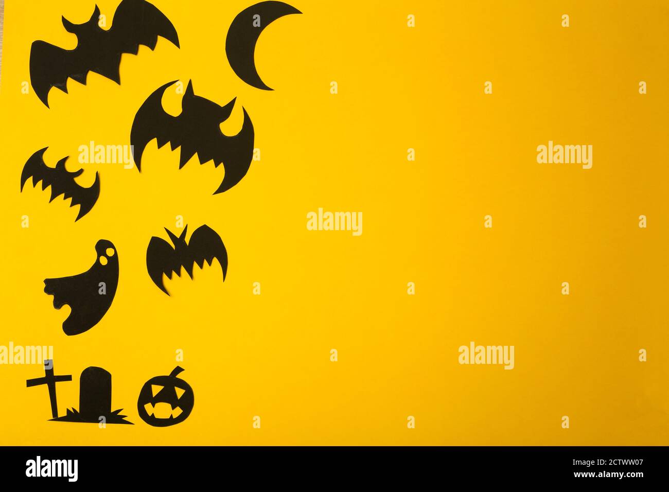 Halloween background. Black bats cut from paper on a yellow background ...