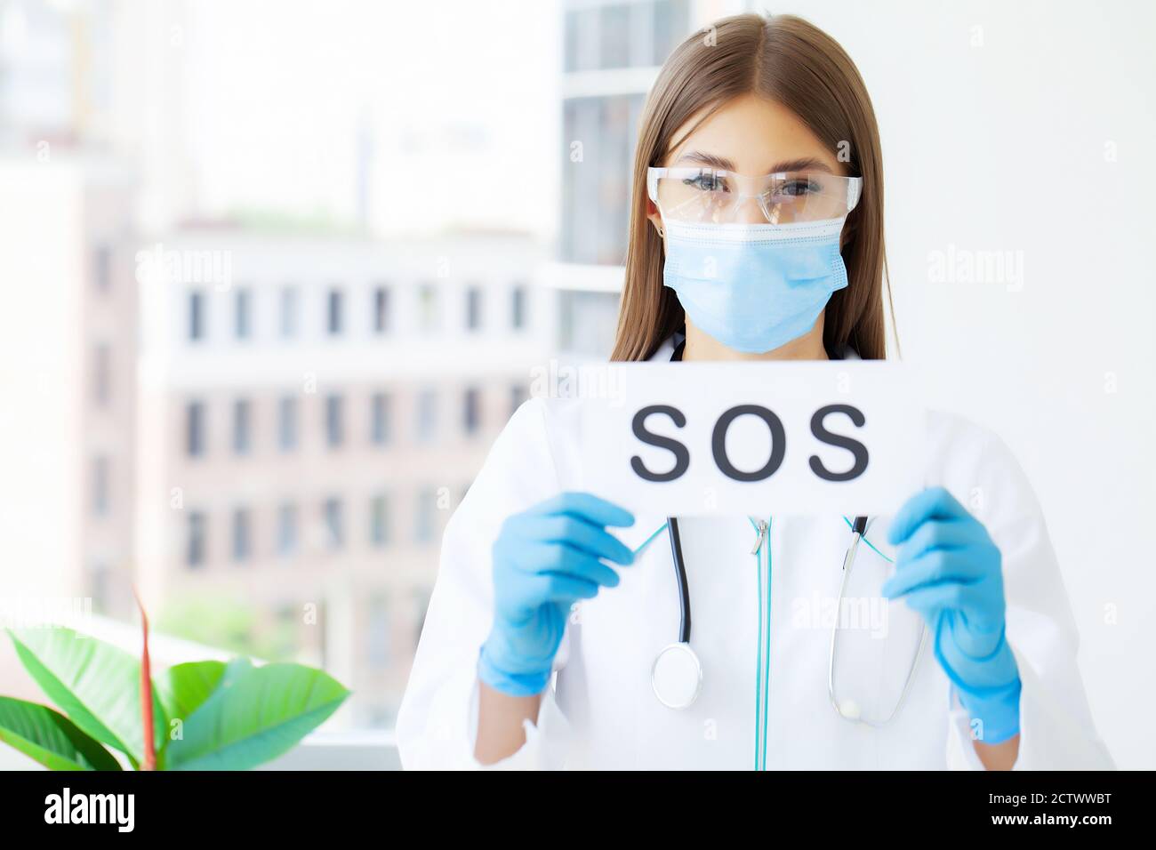The doctor holds a form with the text sos Stock Photo - Alamy