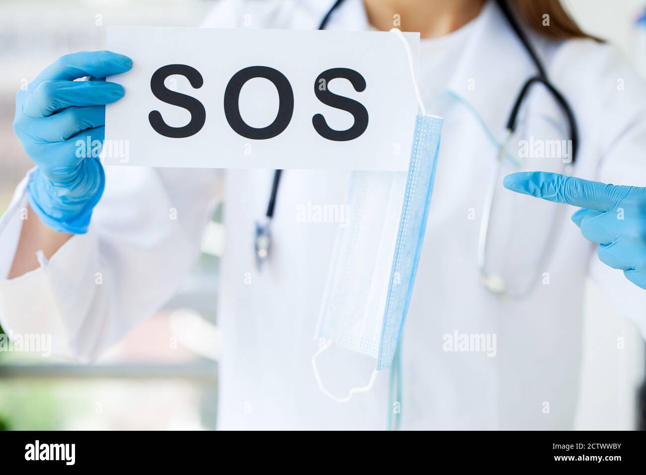 The doctor holds a form with the text sos Stock Photo - Alamy