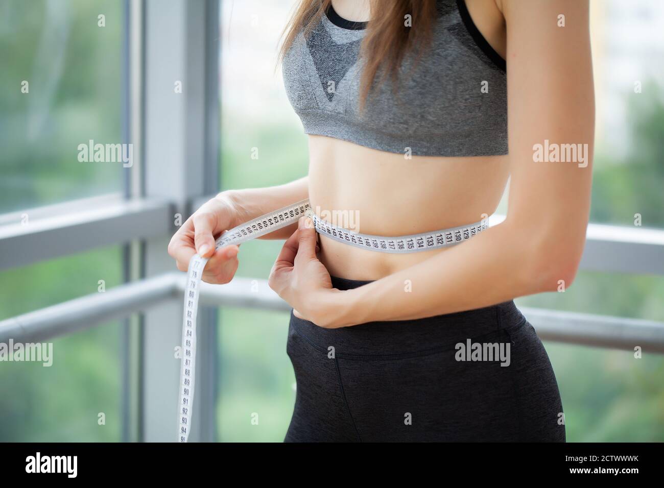 Holding tape measure body part hi-res stock photography and images - Alamy