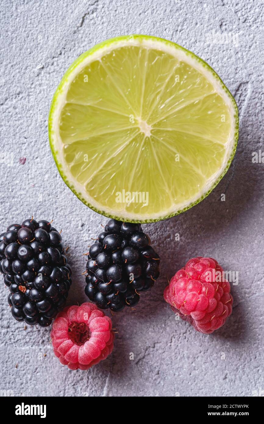 Citrus lime slice, raspberry and blackberry berries, healthy summer ...