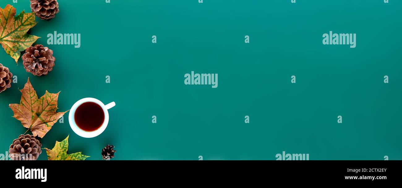 Autumn composition. October dried leaves, pine cones and tea cup ...