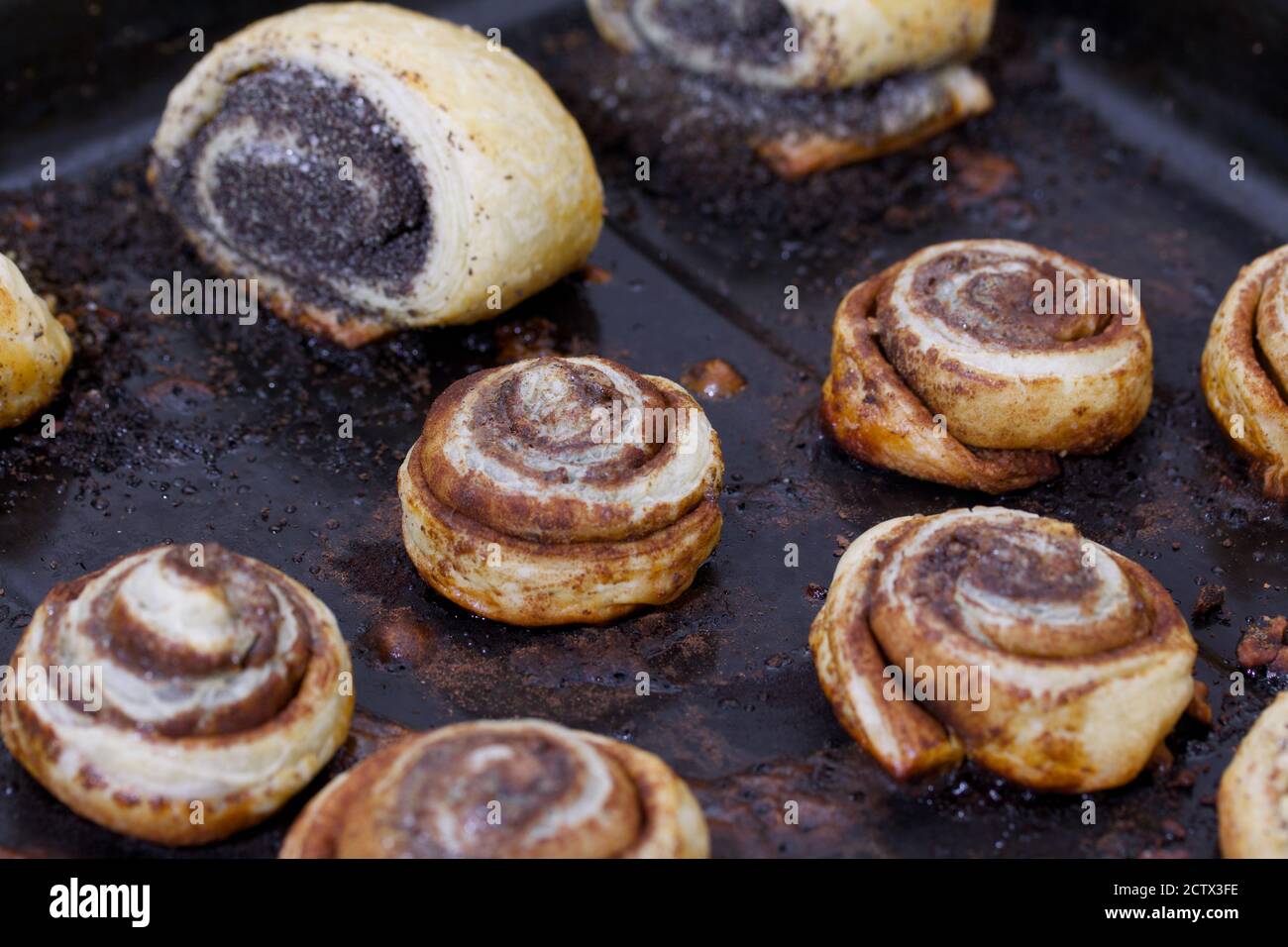 Baked buns stuffed with poppy, cinnamon and walnuts. Lie on a baking ...