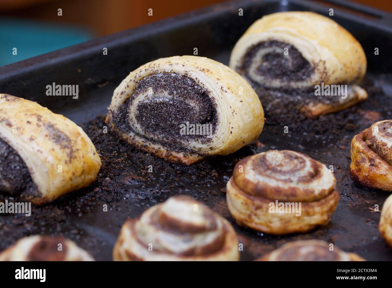 Baked buns stuffed with poppy, cinnamon and walnuts. Lie on a baking ...