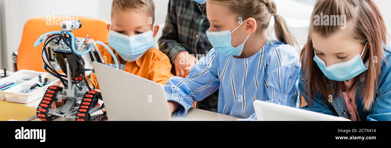 Kids in classroom with masks hi-res stock photography and images - Alamy