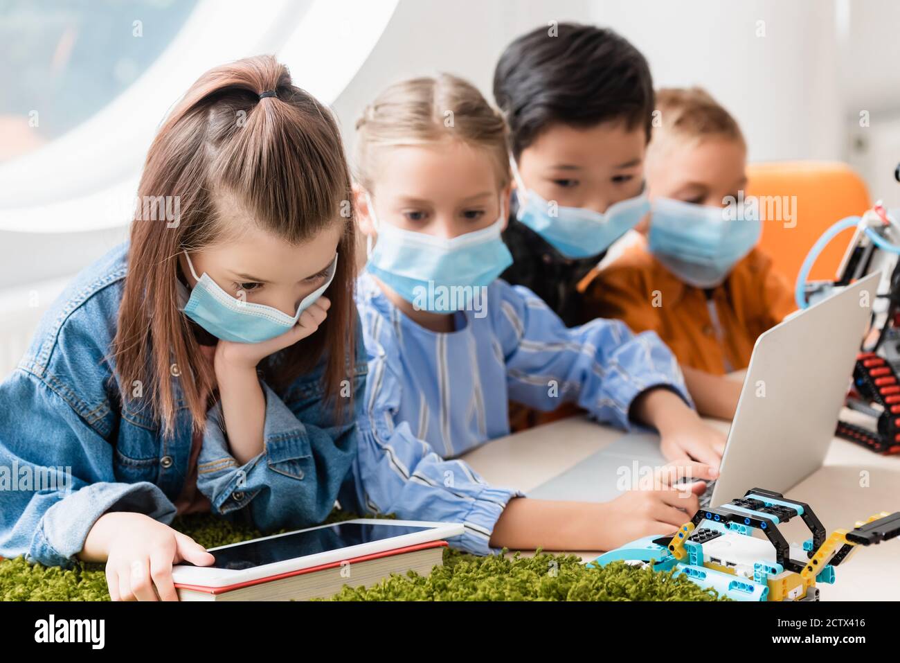 Selective focus of multiethnic schoolkids in medical masks using ...