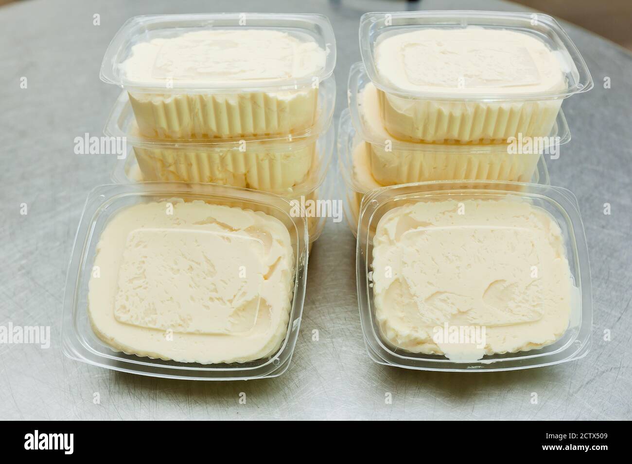Butter packed in a transparent food container, for sale in a store ...