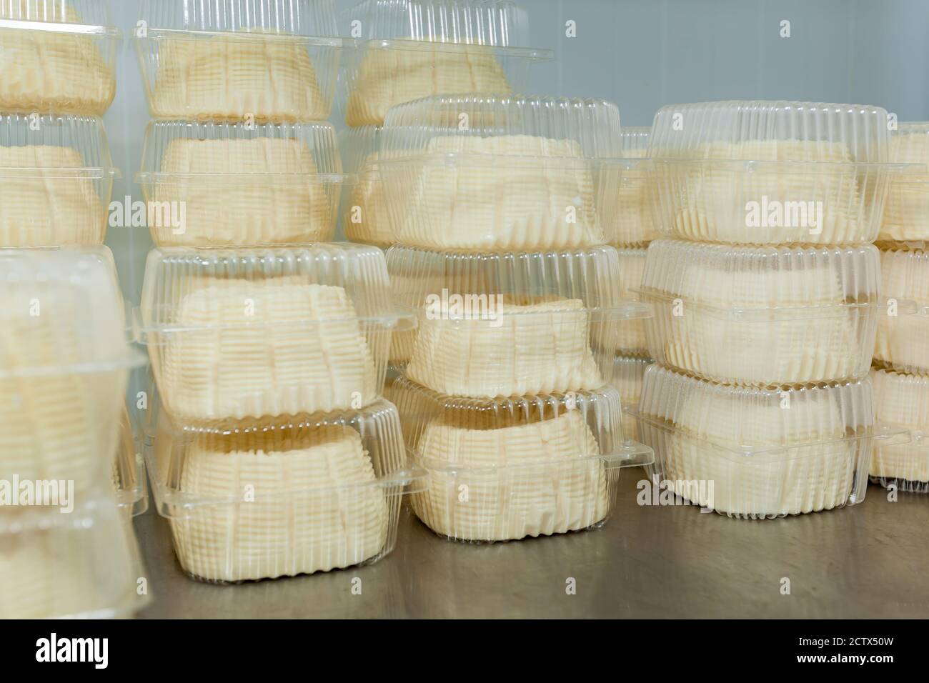 Cheese packed in food-grade transparent containers, for store sale ...