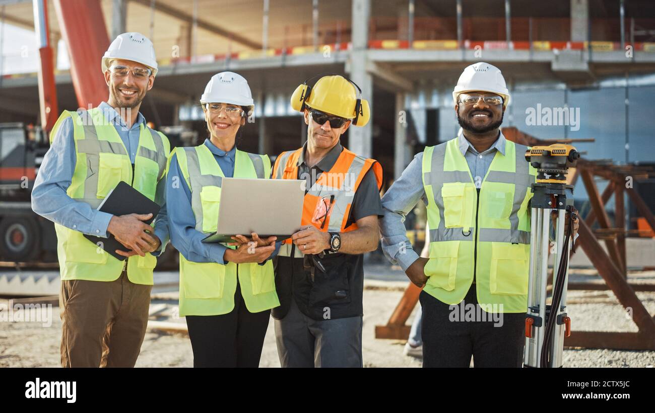 Diverse Team of Specialists Use Laptop Computer on Construction Site ...