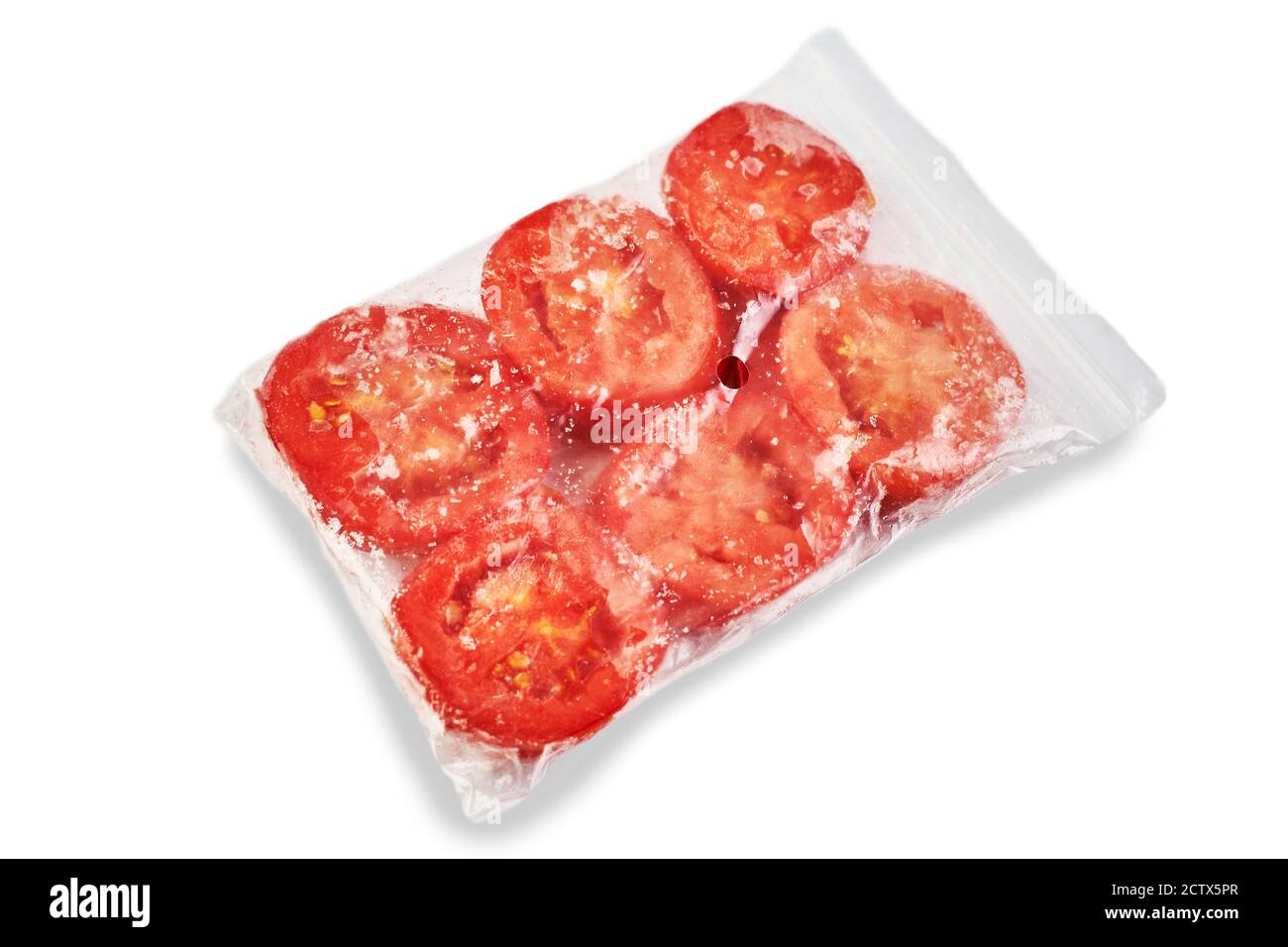 Tomato sliced and packed in a zip bag isolated on white background ...