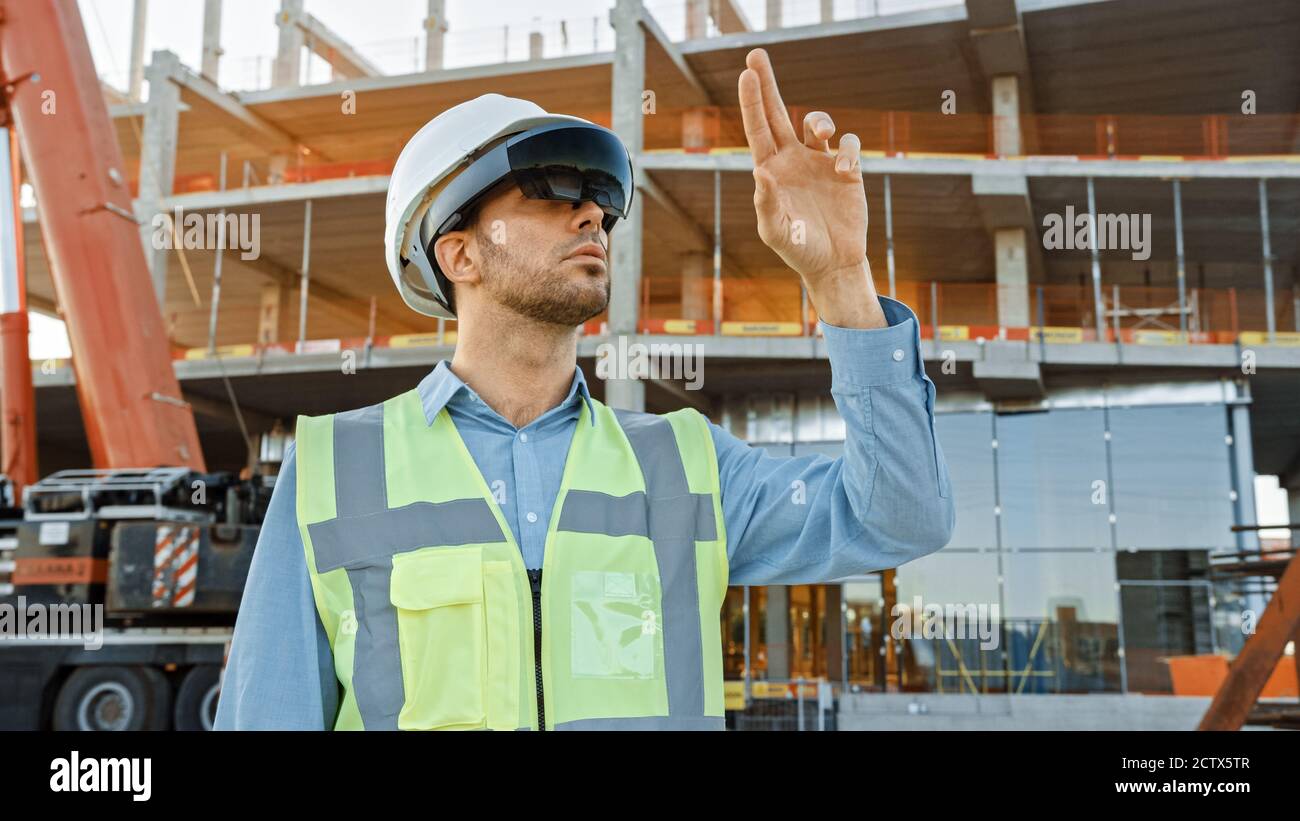 Futuristic Architectural Engineer Wearing Augmented Reality Headset and Using Gestures to ...