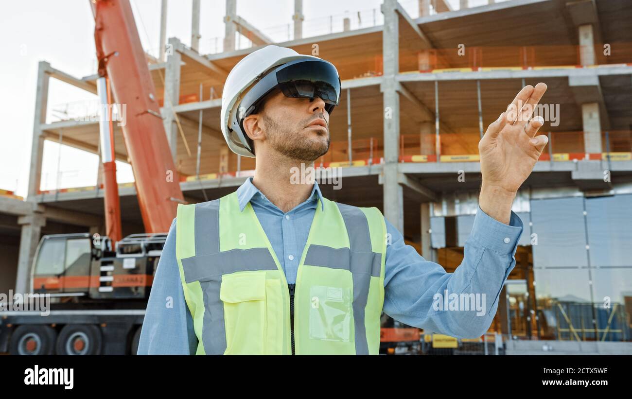 Futuristic Architectural Engineer Wearing Augmented Reality Headset and Using Gestures to ...
