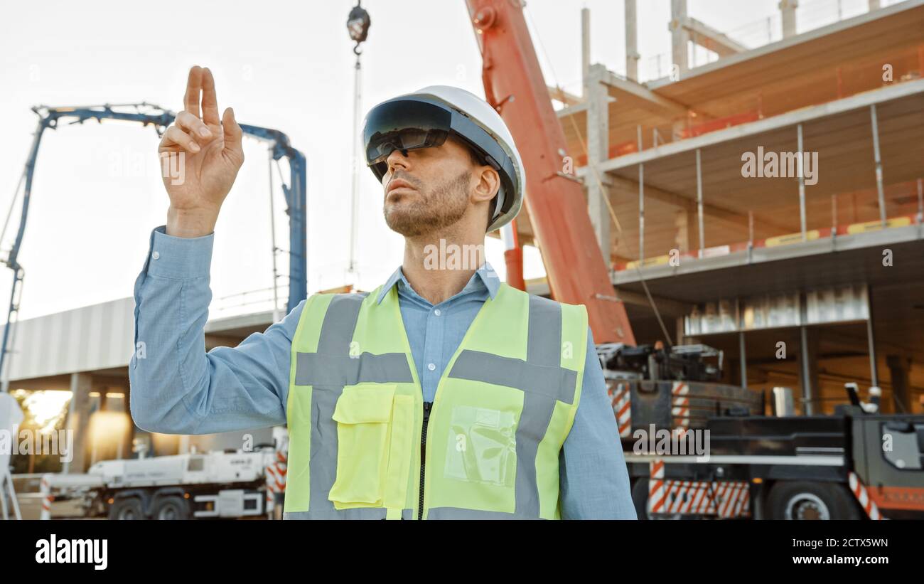 Futuristic Architectural Engineer Wearing Augmented Reality Headset and Using Gestures to ...