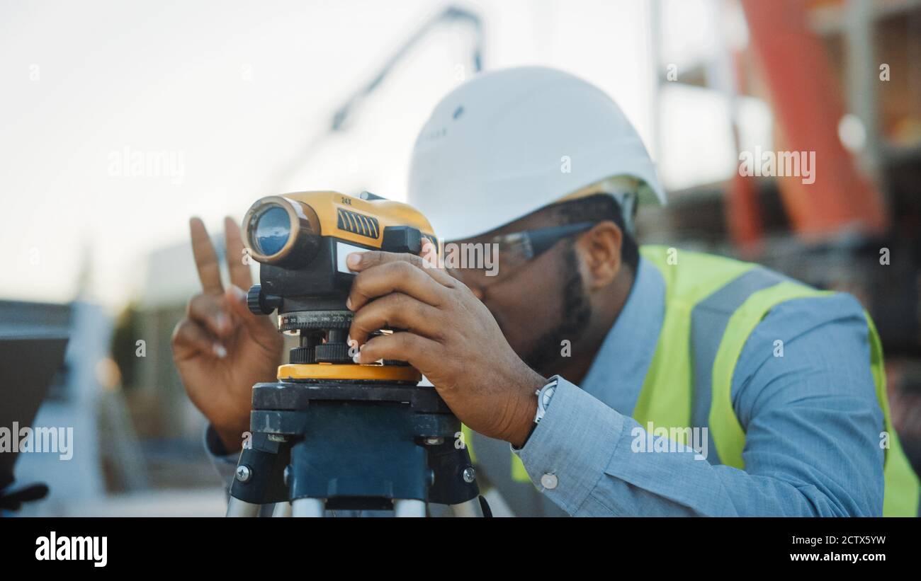 Surveyor in hard hat using surveying hi-res stock photography and ...