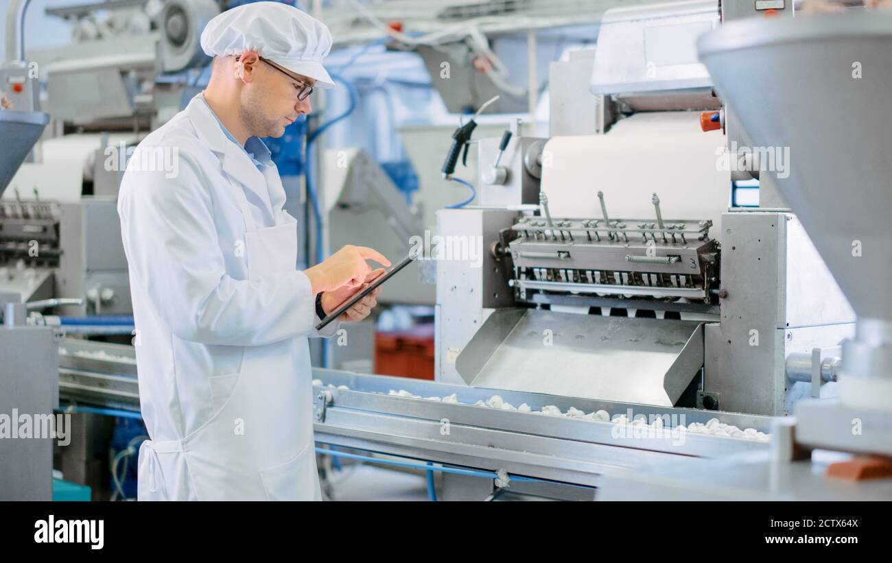 Young Male Quality Supervisor or Food Technician is Inspecting the ...